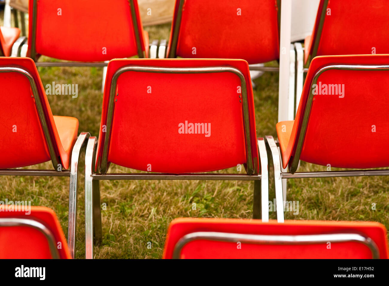 Chairs lined up in rows close-up of backs of the red chairs Stock Photo ...
