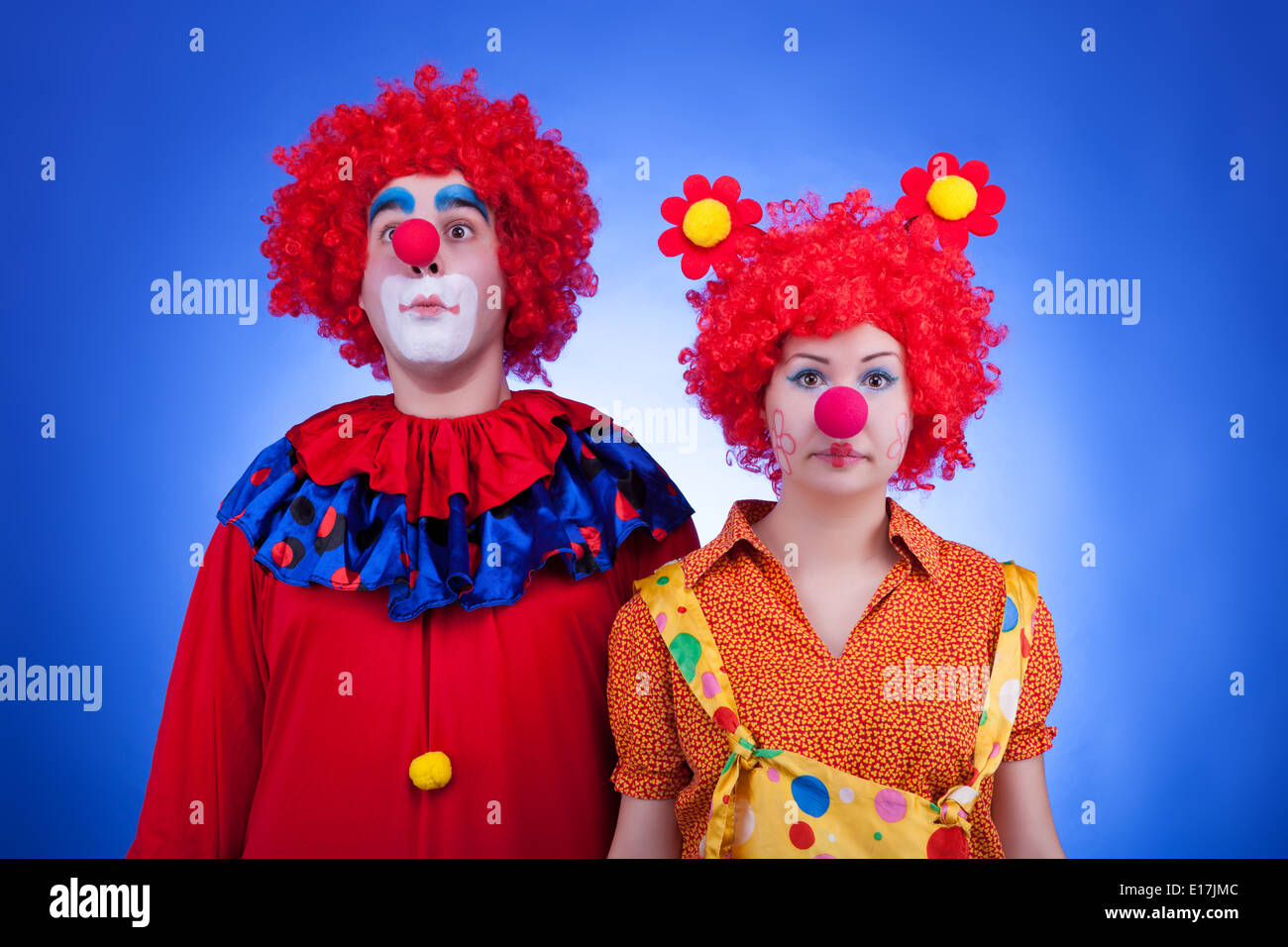 Clown couple on blue background. Professional studio lighting Stock ...