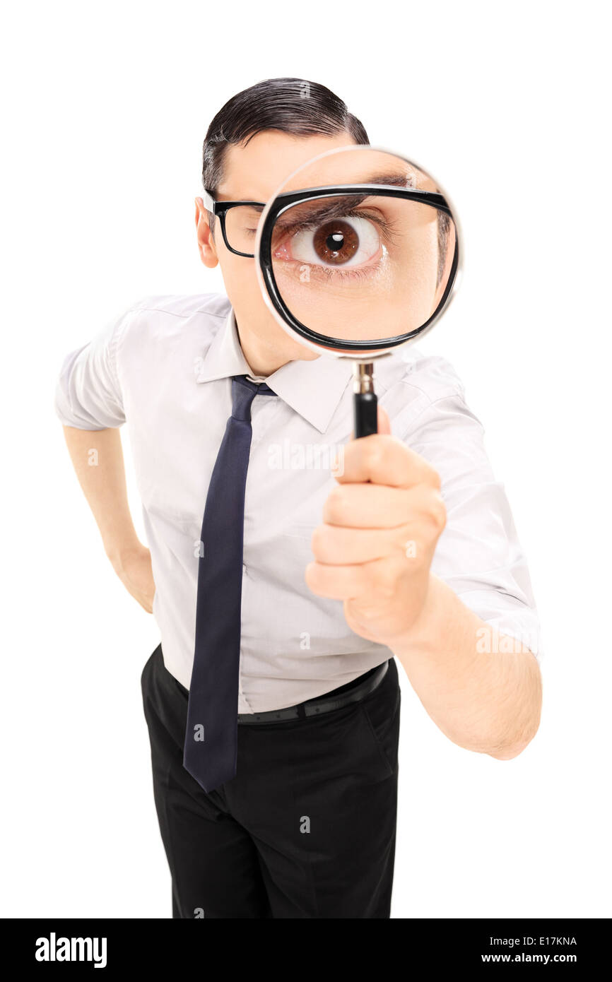 Man looking through a magnifying glass Stock Photo - Alamy