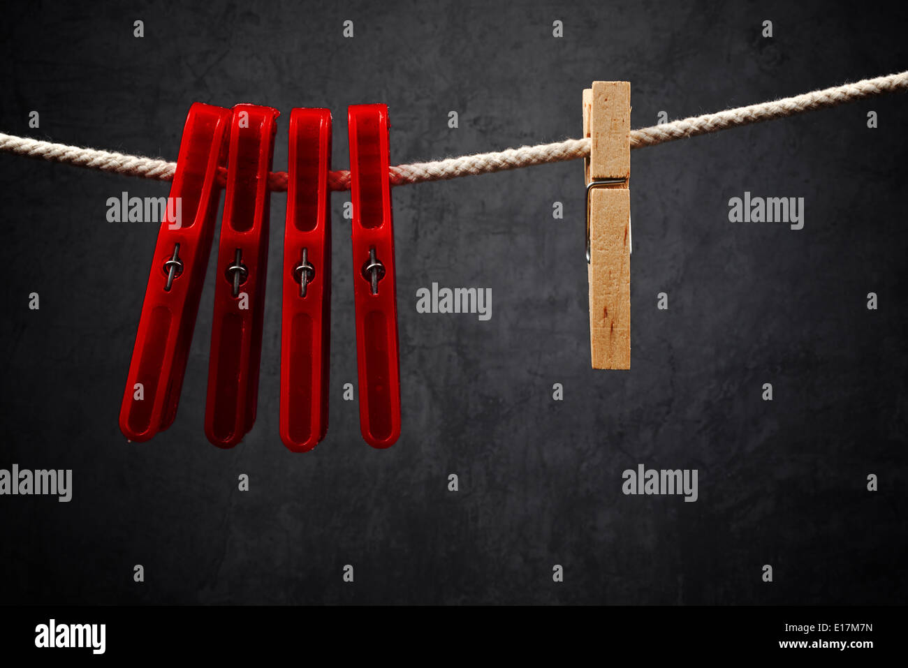 Clothes pins on the rope. Wooden one is Standing out from the crowd ...