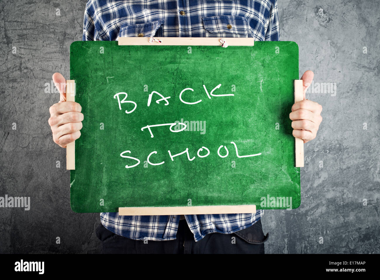 Man holding chalkboard with title back to school Stock Photo - Alamy