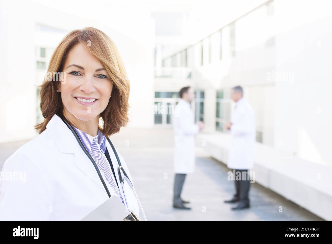 Smiling female medical expert hi-res stock photography and images - Alamy