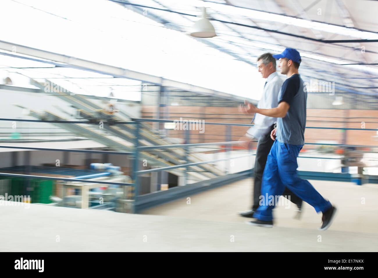 Supervisor and worker walking in food processing plant Stock Photo - Alamy