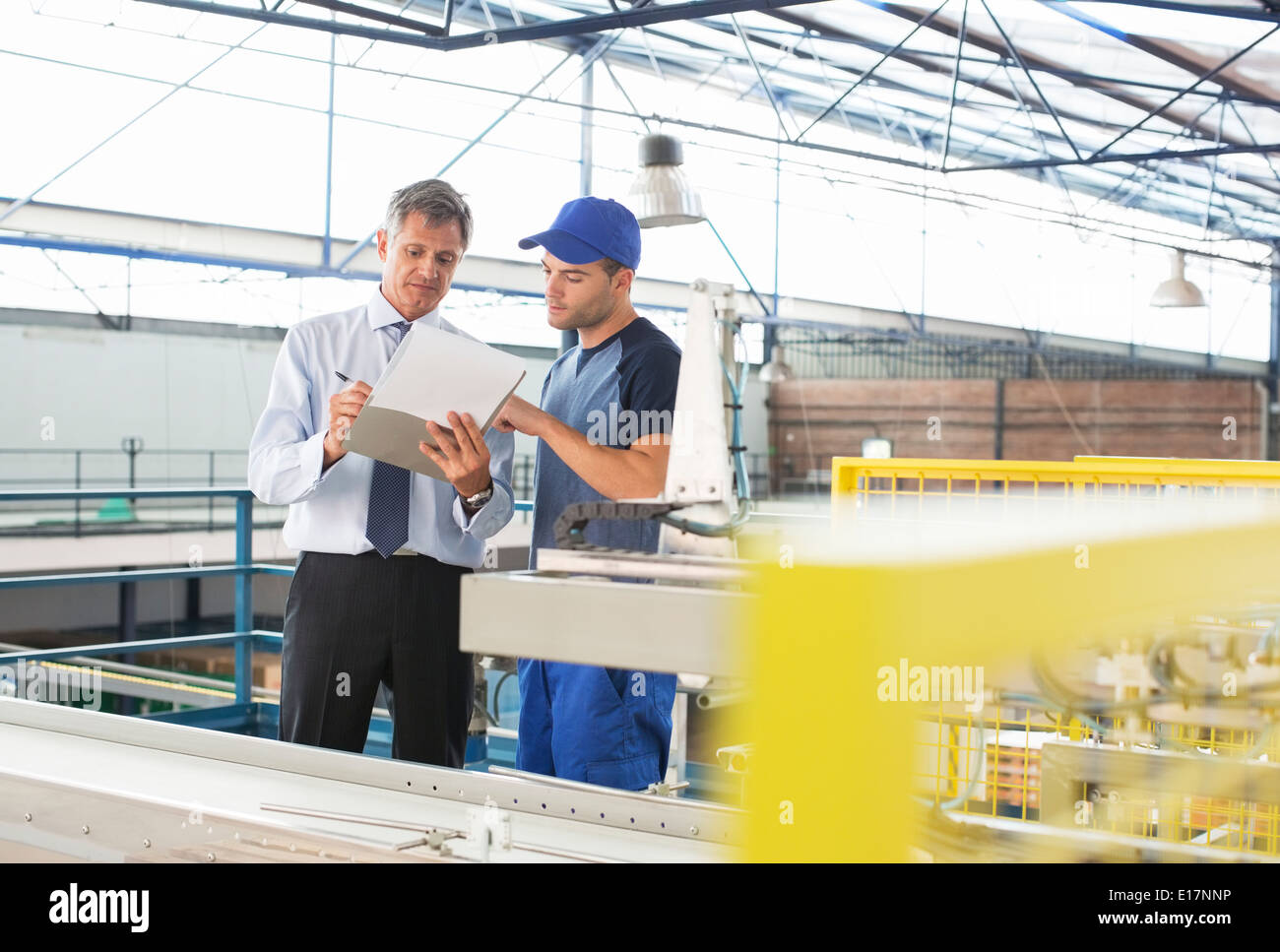 Supervisor and worker with clipboard in food processing plant Stock ...