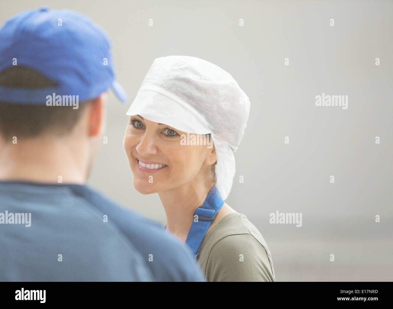Workers talking in food processing plant Stock Photo - Alamy