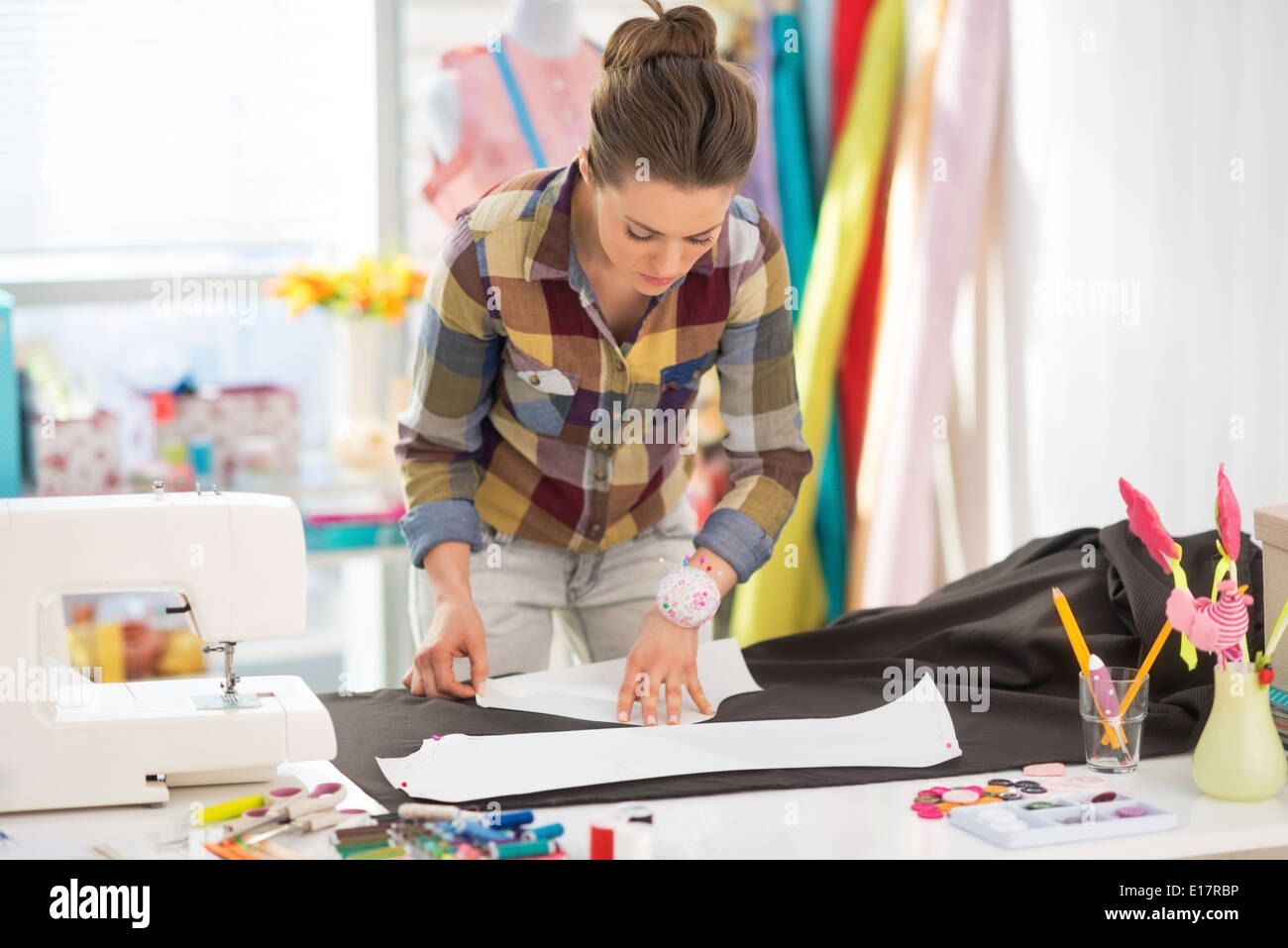 Seamstress making pattern on fabric Stock Photo - Alamy