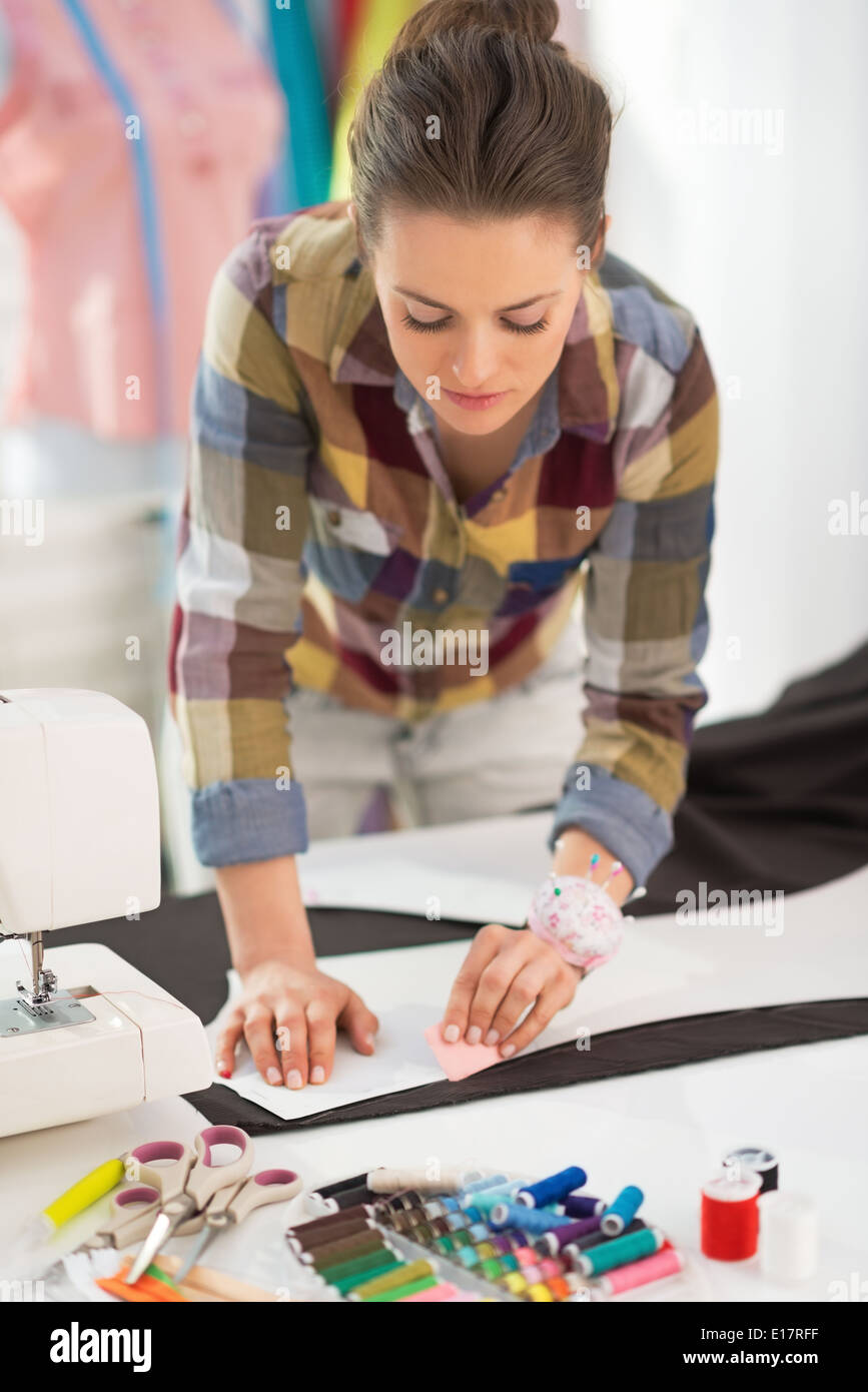 Seamstress making pattern on fabric Stock Photo - Alamy