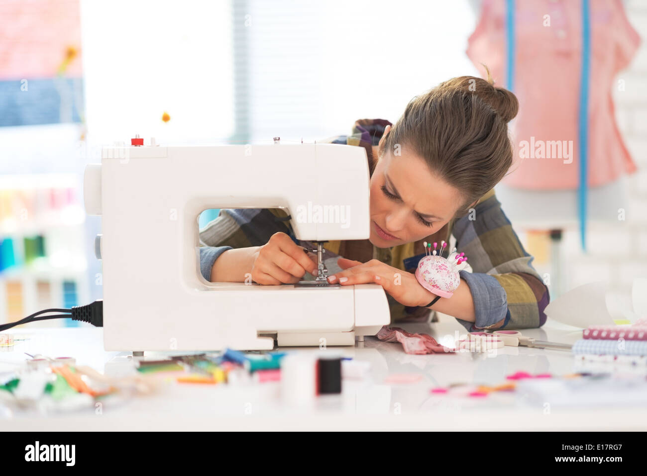 Seamstress working with sewing machine Stock Photo - Alamy