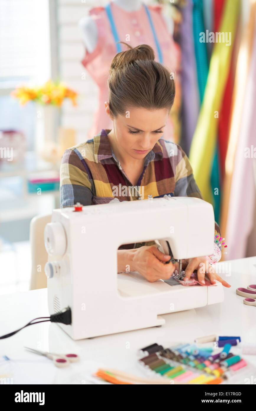 Seamstress working with sewing machine Stock Photo - Alamy