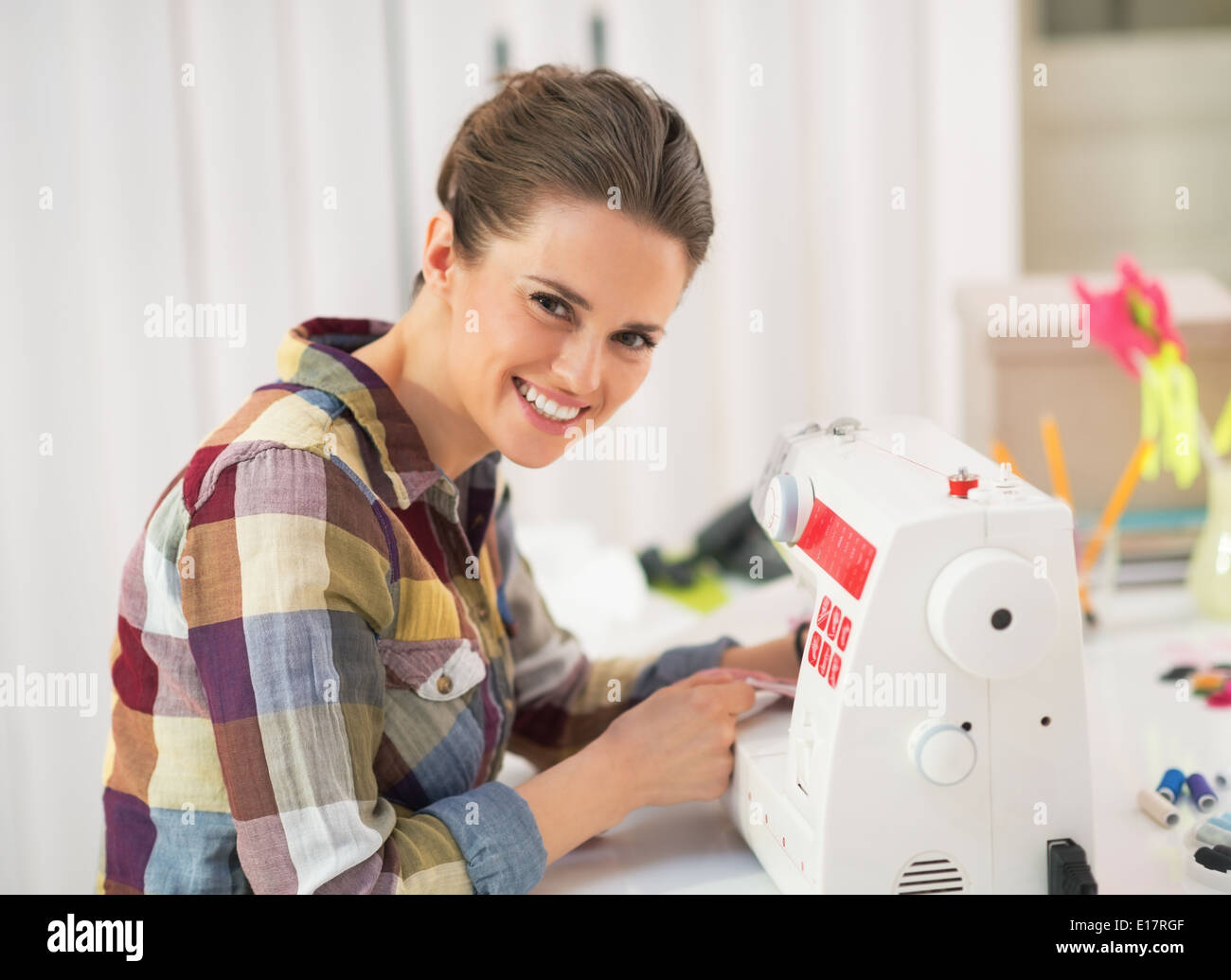 Seamstress working with sewing machine Stock Photo - Alamy