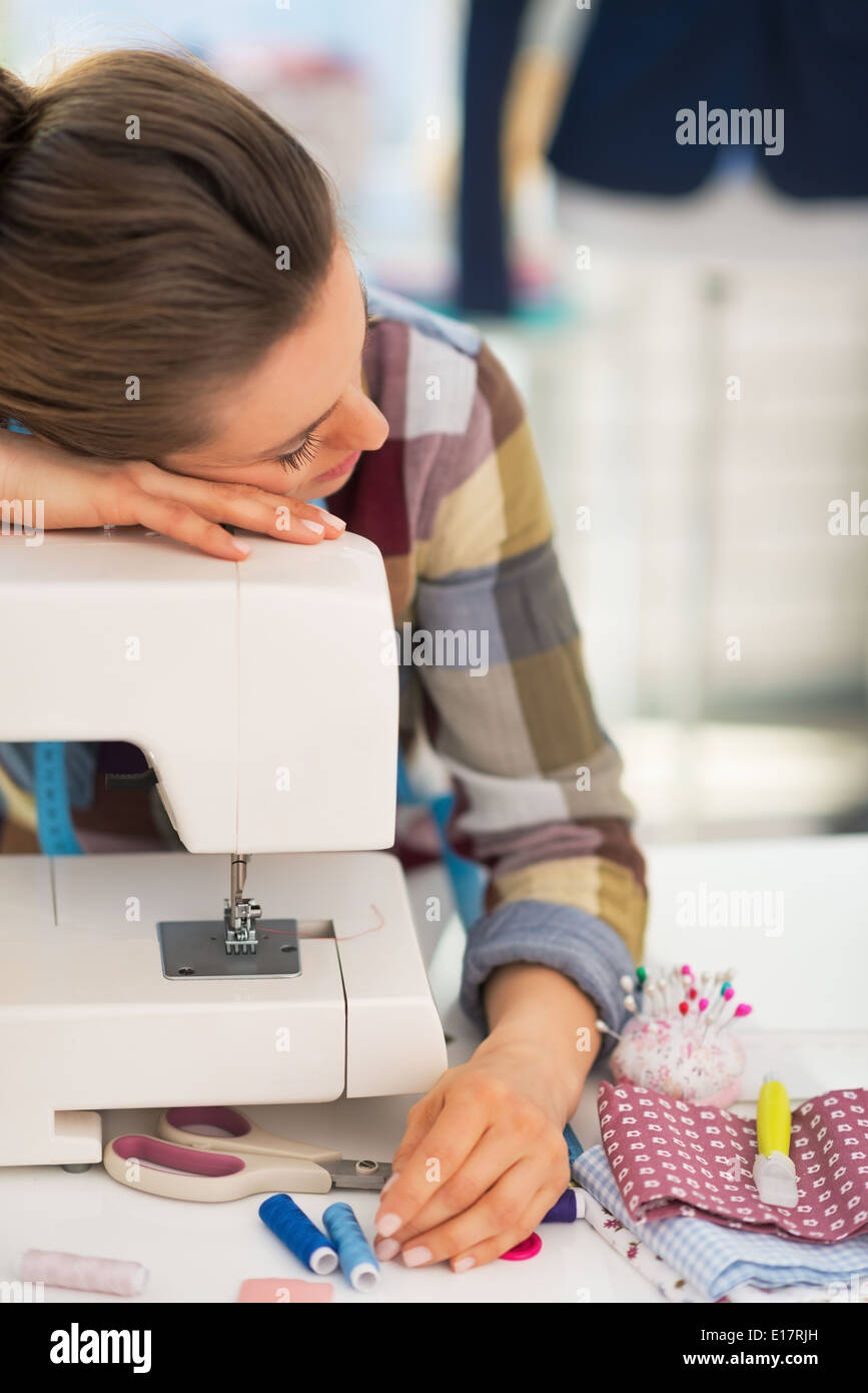Tired seamstress sleeping on sewing machine Stock Photo - Alamy