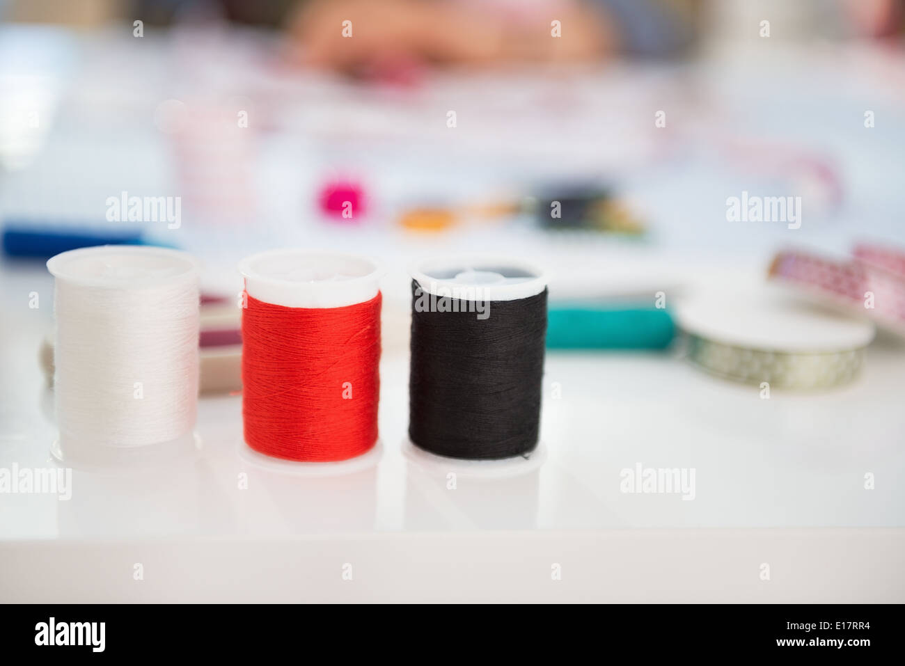 Closeup on threads on table Stock Photo - Alamy
