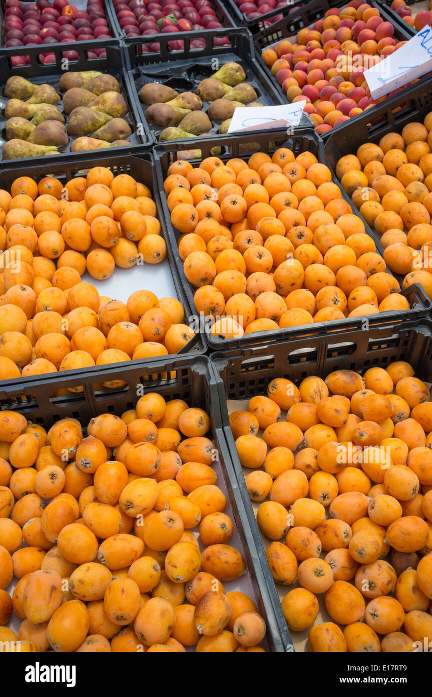 Loquats and other spring fruit on a market stall Stock Photo - Alamy