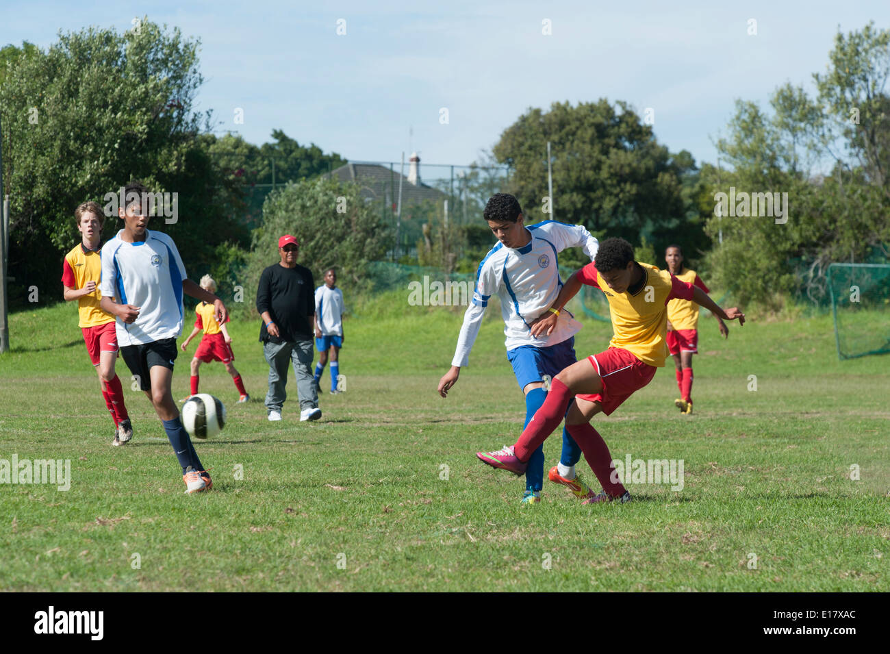 Junior football players tackling and kicking the ball, Cape Town, South ...