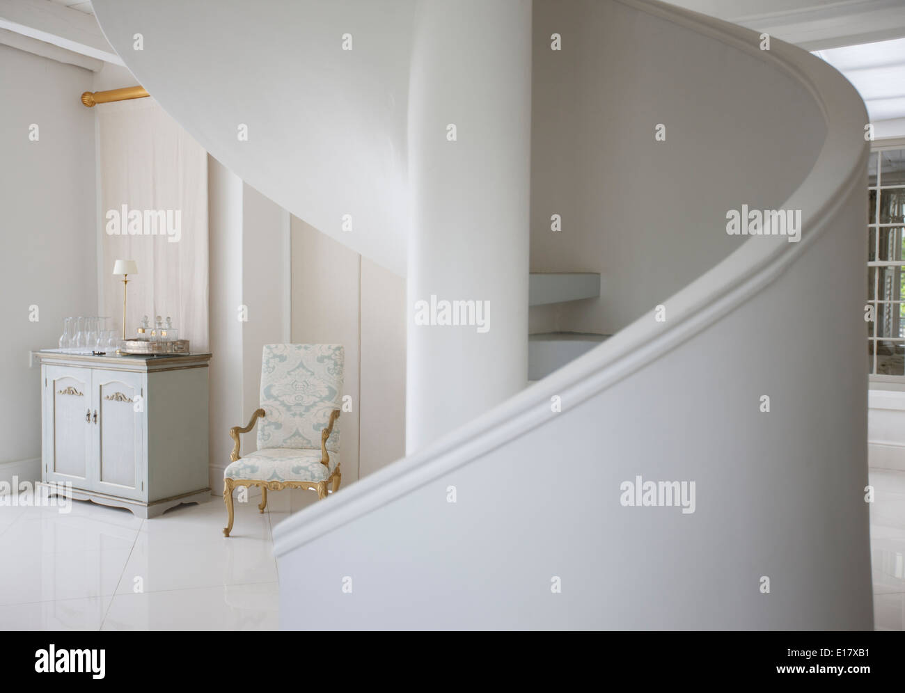 Spiral staircase in luxury foyer Stock Photo - Alamy
