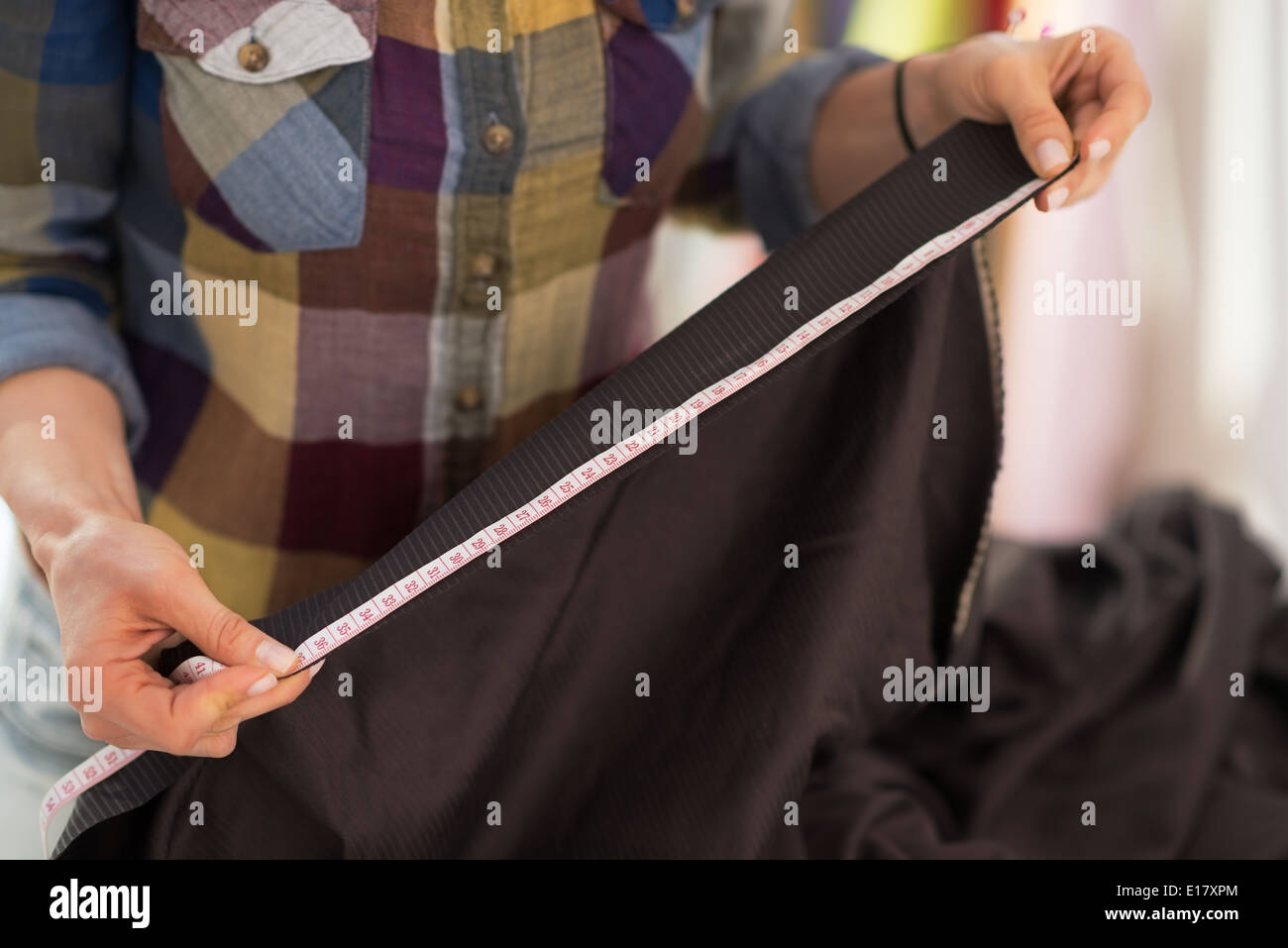 Closeup on seamstress measuring fabric Stock Photo - Alamy