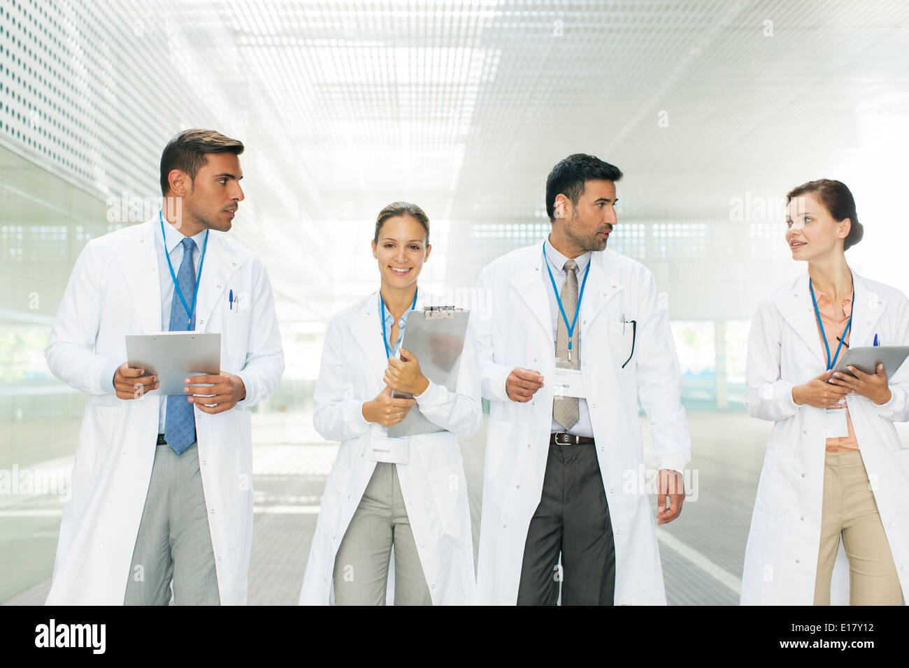 Doctor walking in corridor hi-res stock photography and images - Alamy
