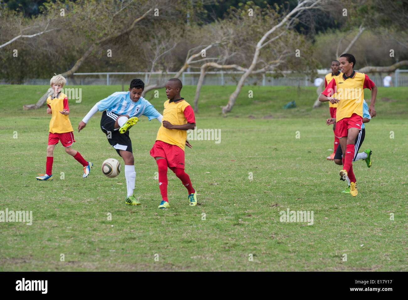 Junior football players tackling and kicking the ball, Cape Town, South ...