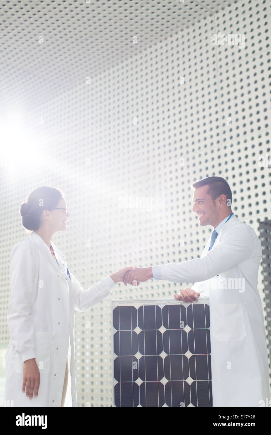 Scientists shaking hands in lab hi-res stock photography and images - Alamy