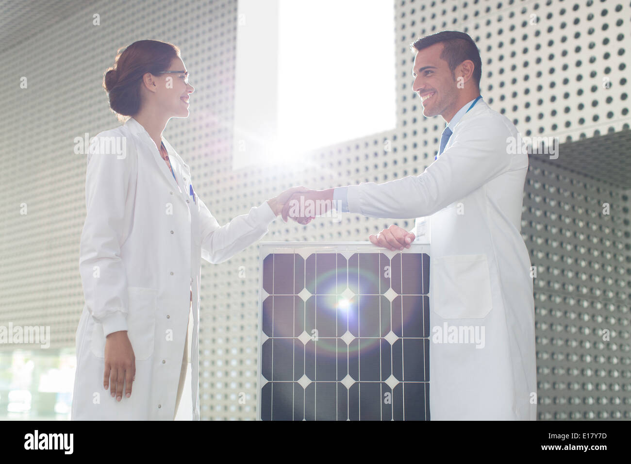Scientists shaking hands in lab hi-res stock photography and images - Alamy