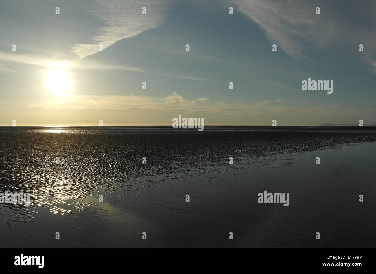 Blue sky view, to sun sinking over sea, inverted V cirrus clouds ...