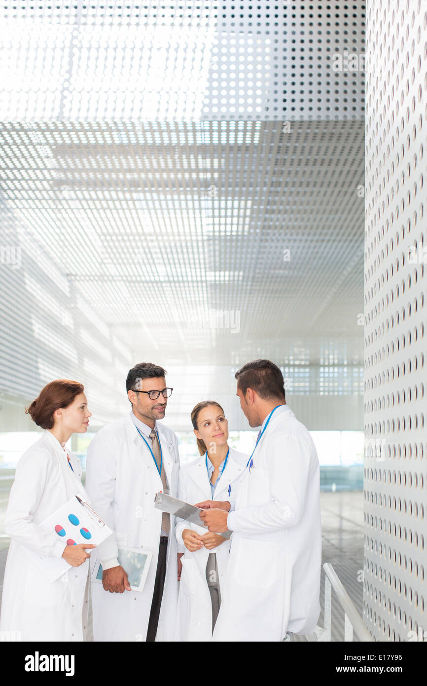 Doctors talking in hospital corridor Stock Photo - Alamy