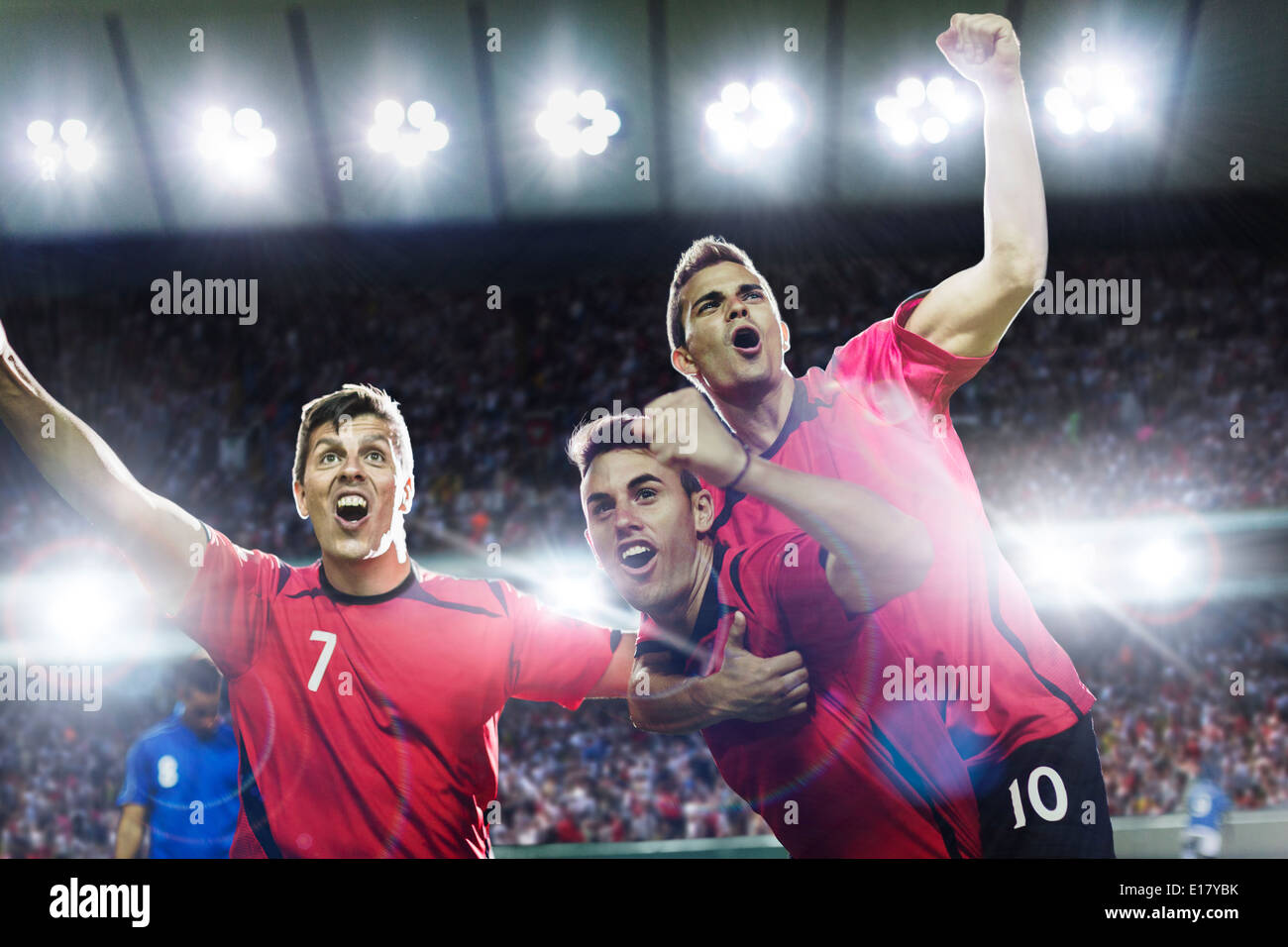 Soccer players celebrating on field Stock Photo - Alamy