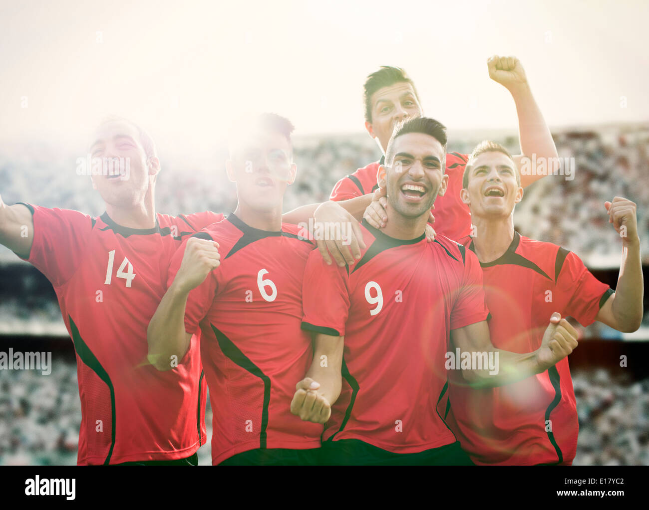 Soccer team celebrating on field Stock Photo - Alamy
