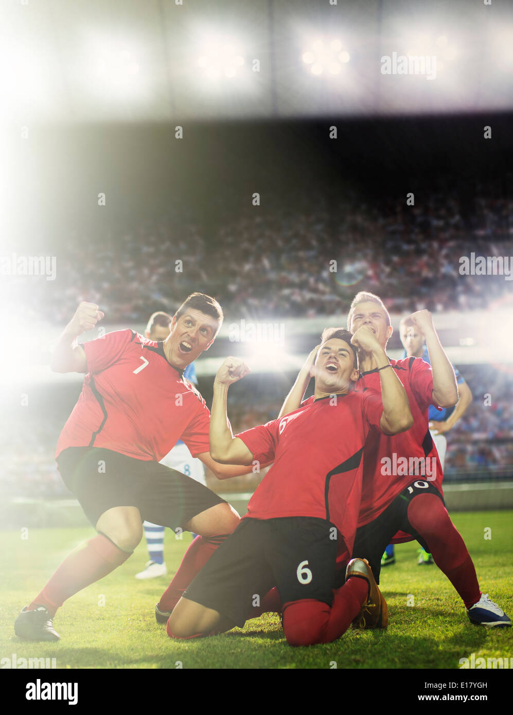 Soccer team celebrating on field Stock Photo - Alamy
