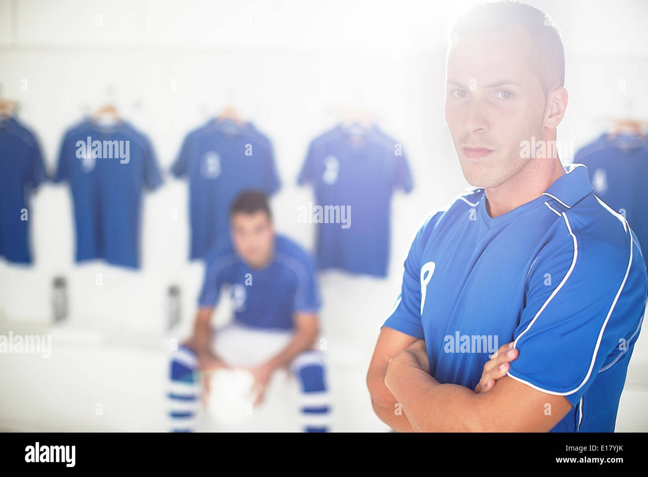 Soccer player standing in locker room Stock Photo - Alamy