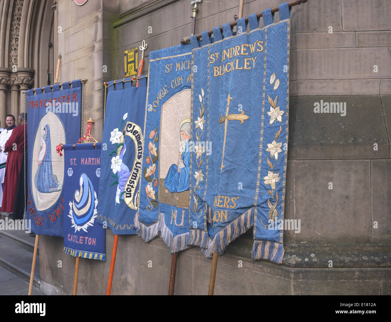 Manchester, UK 26th May 2014 Parish banners rest on the wall at the ...
