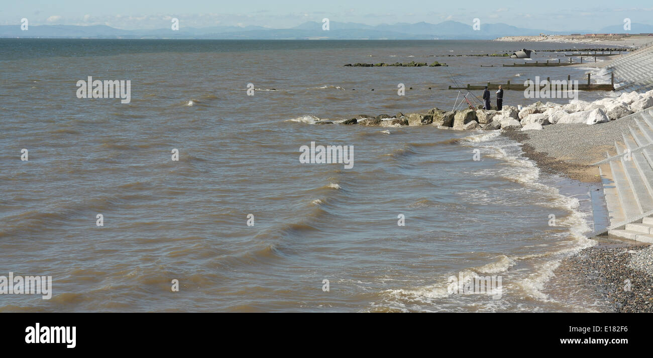 Blue sky high tide beach view, to Cumbrian Mountains, fishermen ...