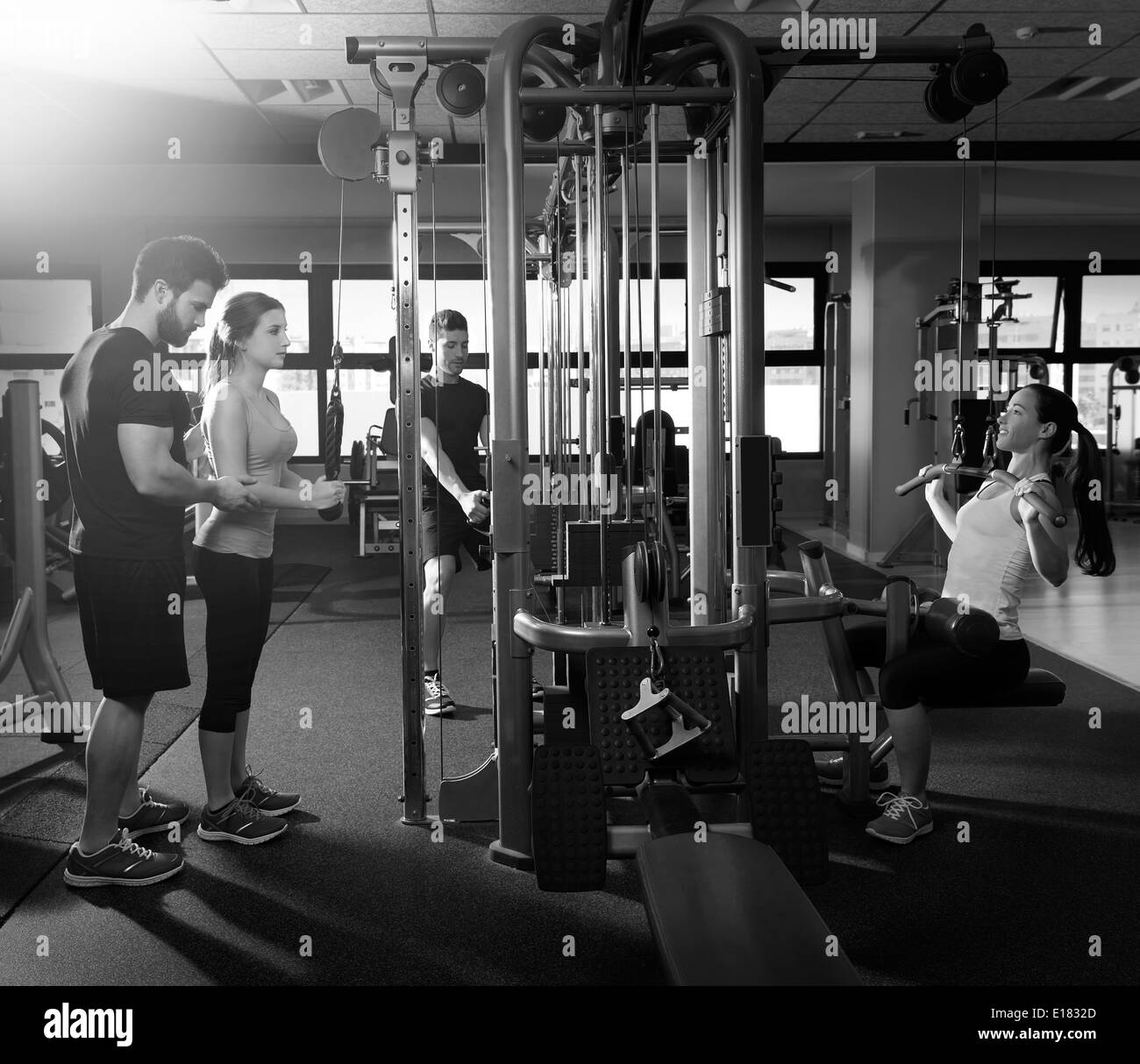 cable pulley system gym workout fitness people with personal trainer ...