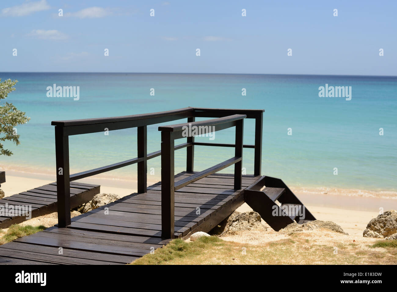 wooden jetty with steps leading down to a white sandy beach on the ...