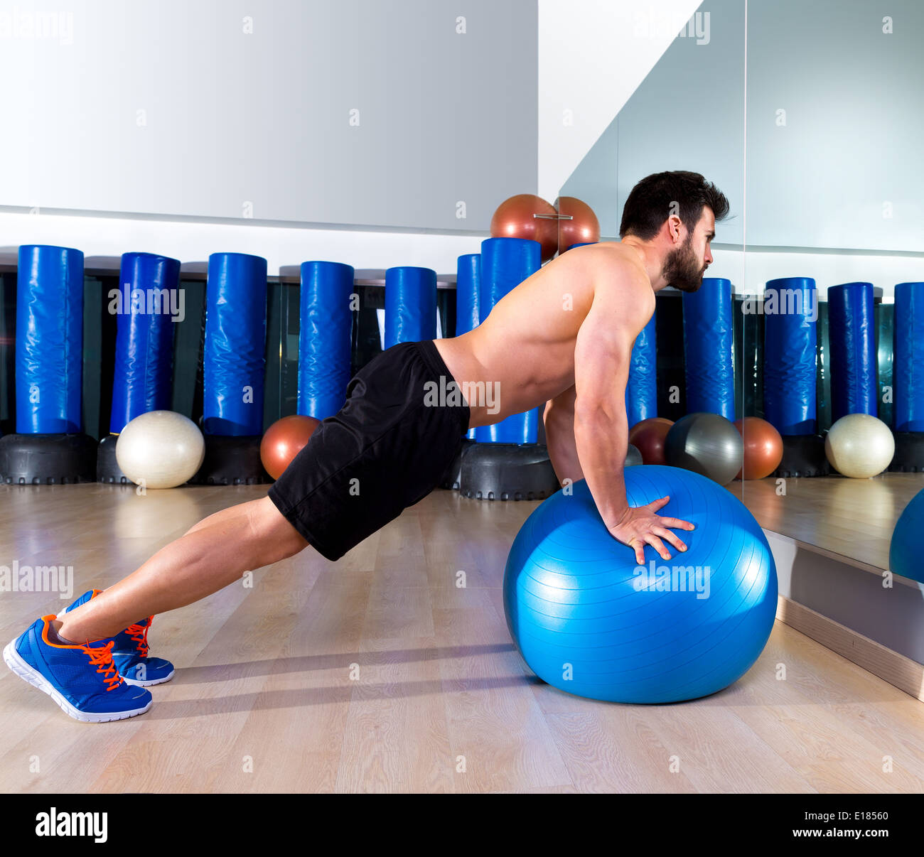 Fitball abdominal push ups Swiss ball man pushup at fitness gym Stock ...