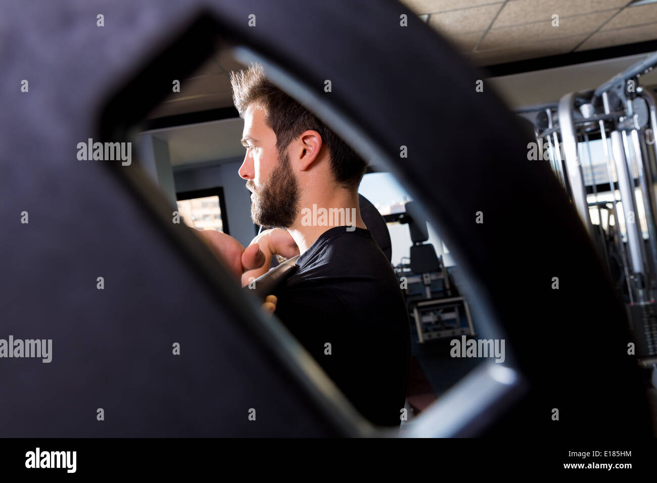 Barbell man weightlifting workout view through a weight bell hole Stock ...