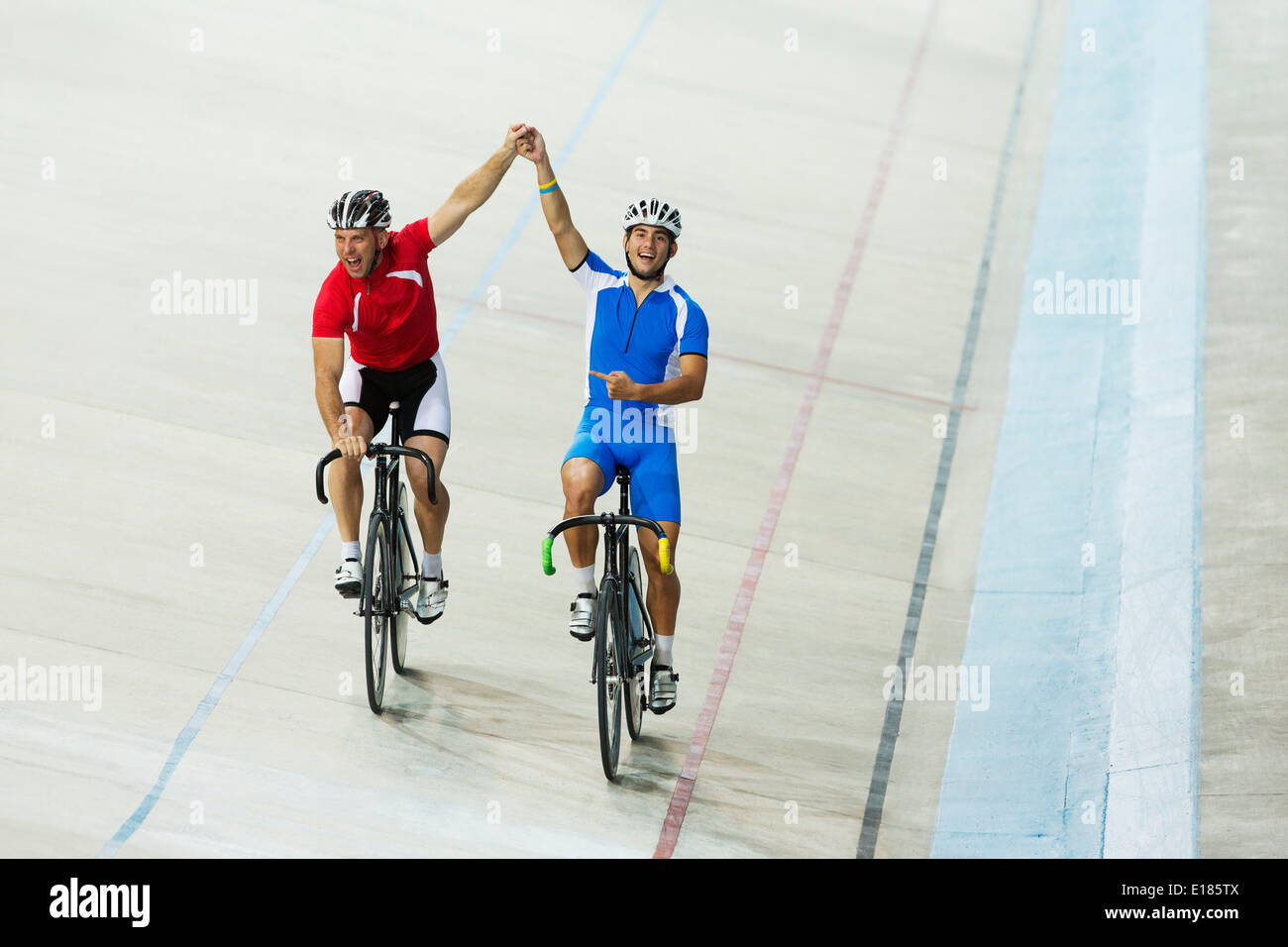 Track cyclists celebrating in velodrome Stock Photo - Alamy