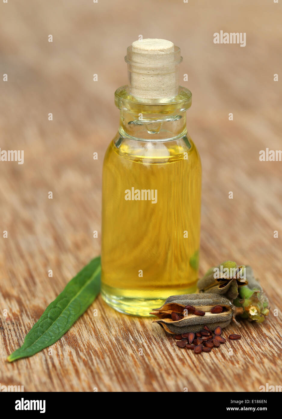 Sesame seeds with oil on wooden surface Stock Photo - Alamy