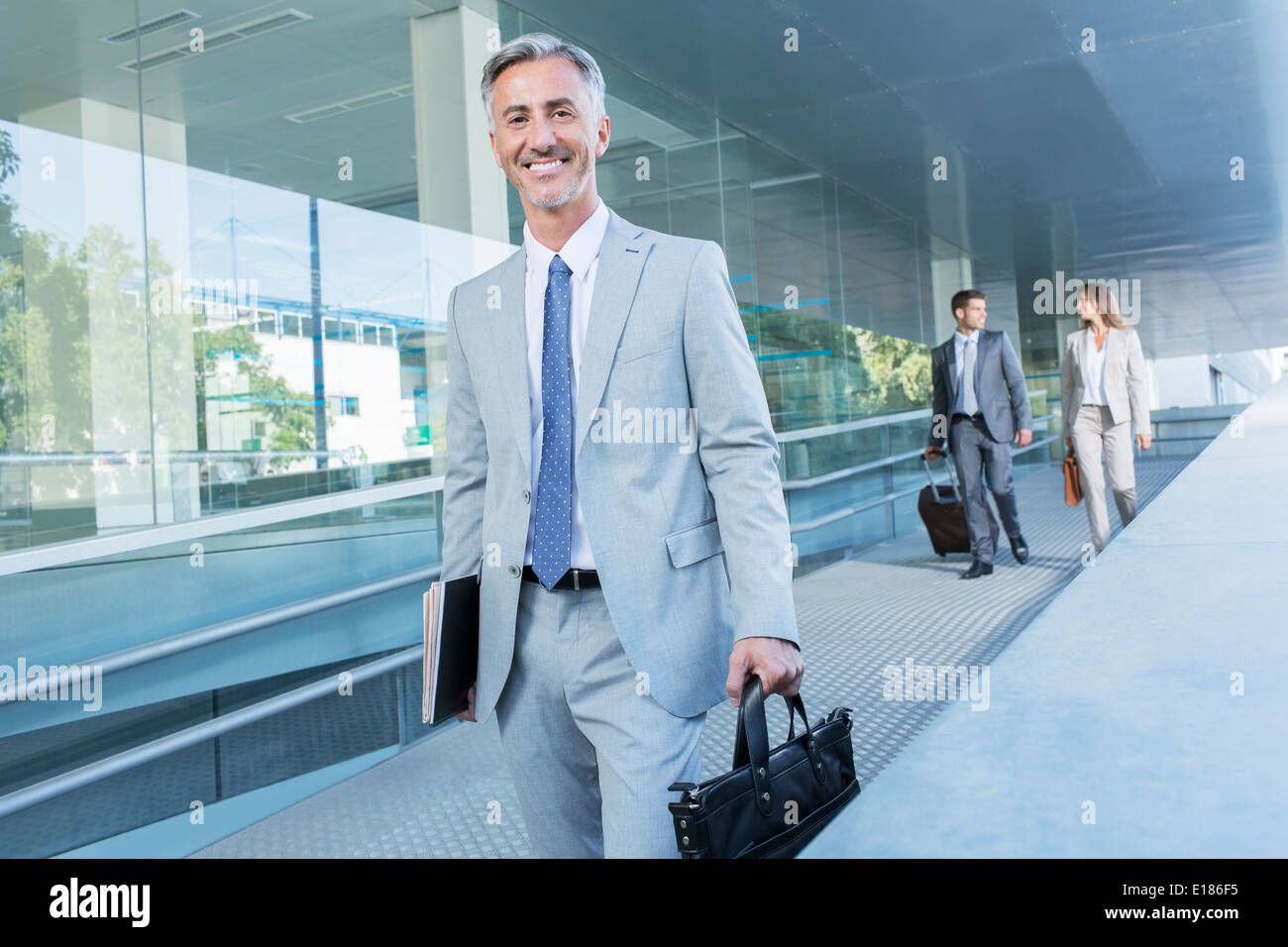 Portrait of businessman leaving office Stock Photo - Alamy