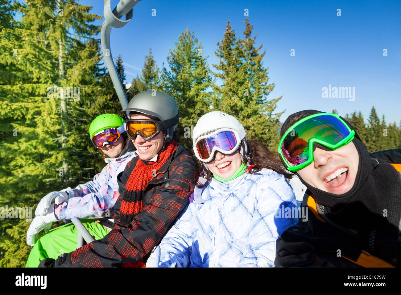 Smiling snowboarders in ski masks on elevator Stock Photo - Alamy