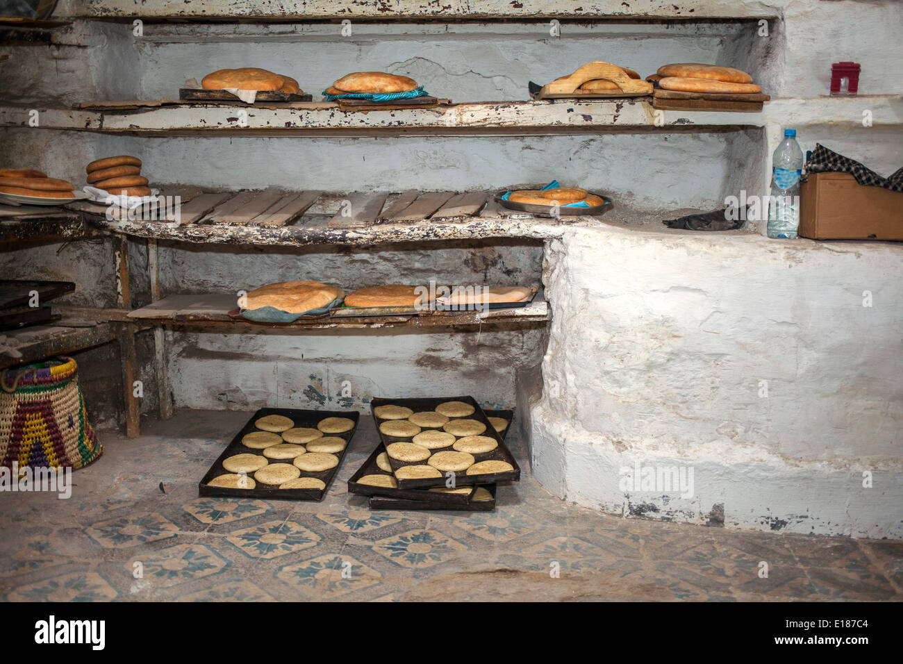 Moroccan bakery in Fez with trays filled with bread on shelves and ...