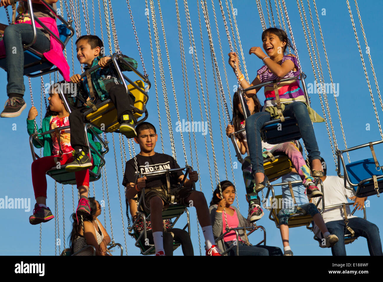 Happy, excited kids twirling in the air on a carnival ride Stock Photo ...