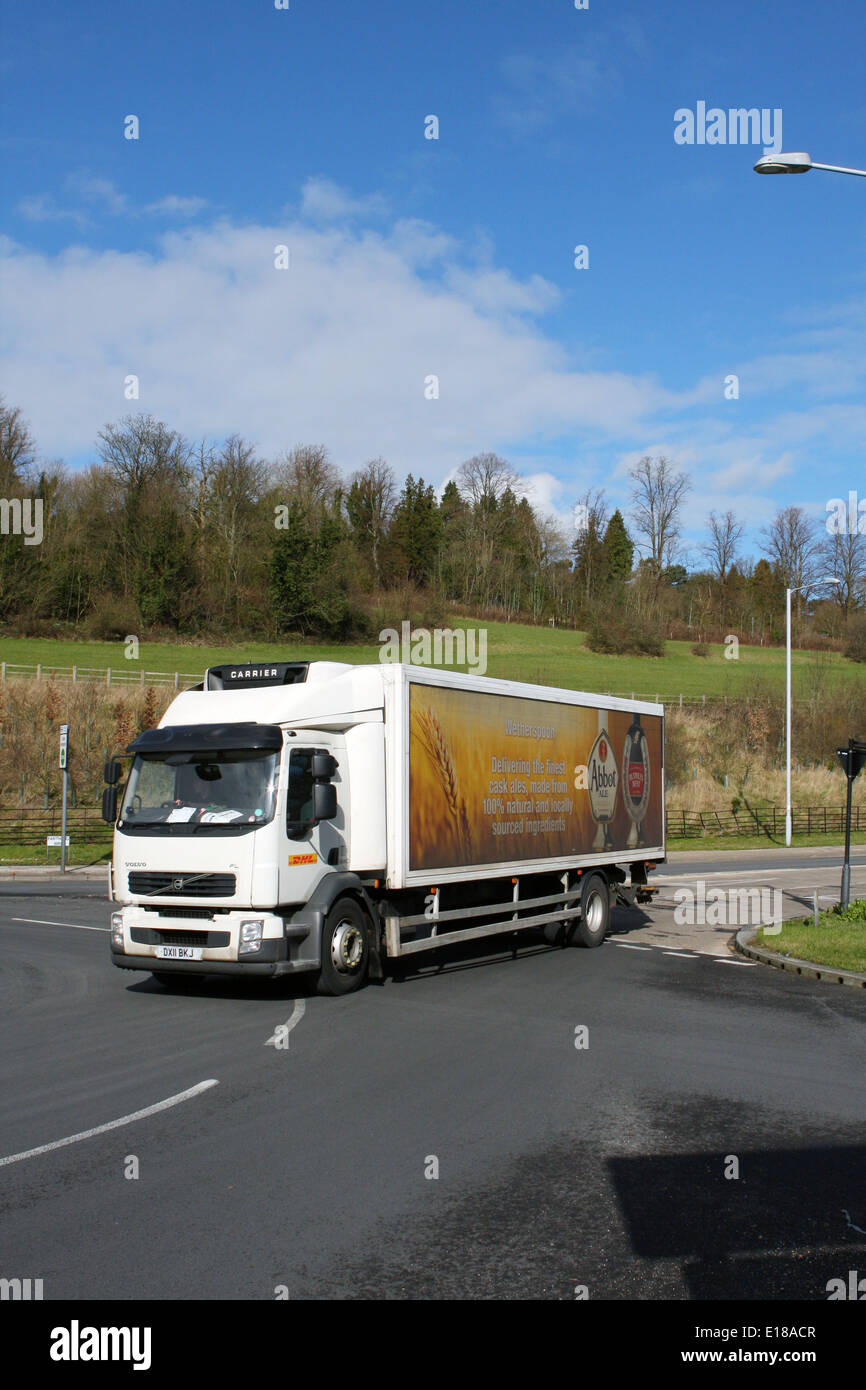 A DHL truck, with JD Wetherspoons advertising entering a roundabout in ...