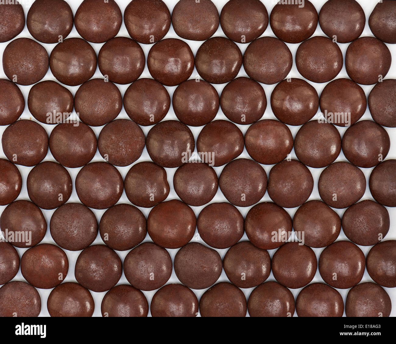 Dark brown dragee in chocolate covered. Whole background Stock Photo ...