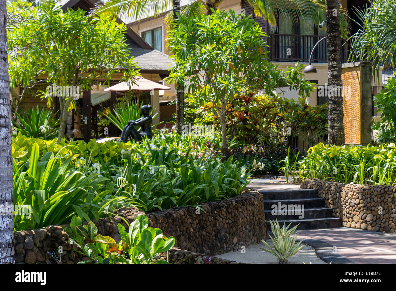 Stone wall and balustrade with steps leading to a gated entrance in a ...
