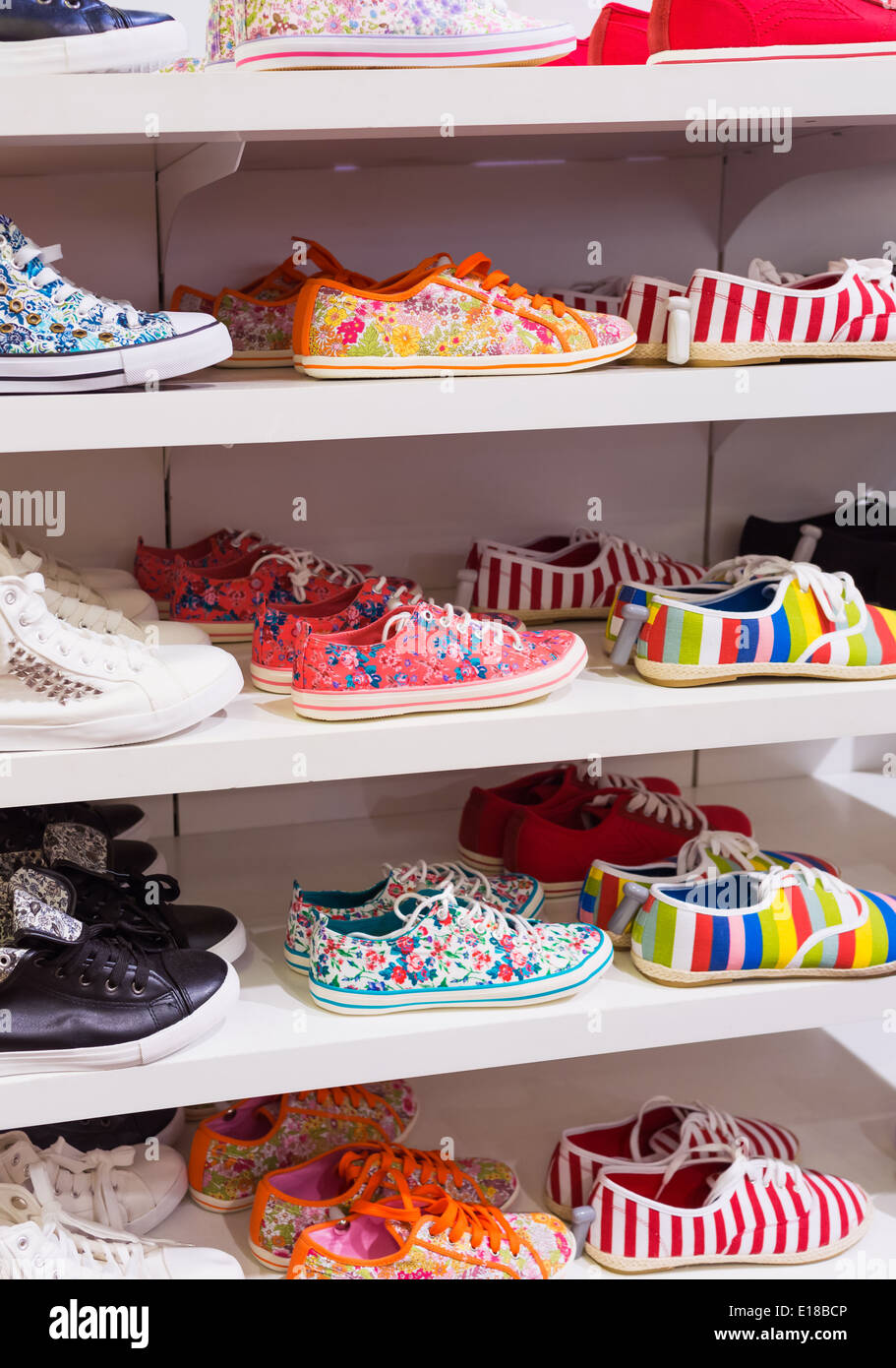 Background with shoes on shelves of shop Stock Photo - Alamy