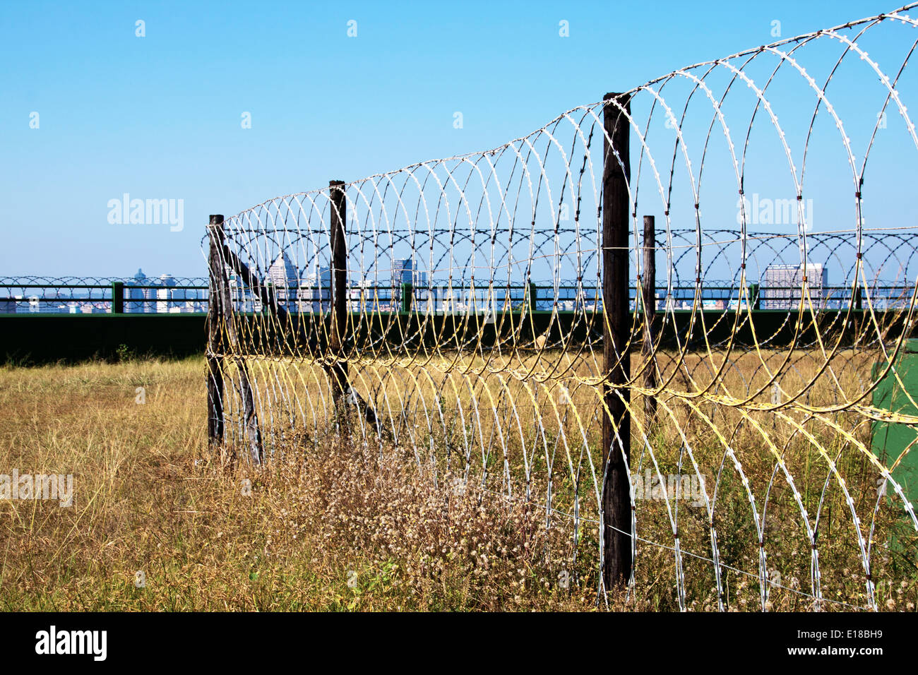 razor wire security fence surrounding protected structure Stock Photo ...