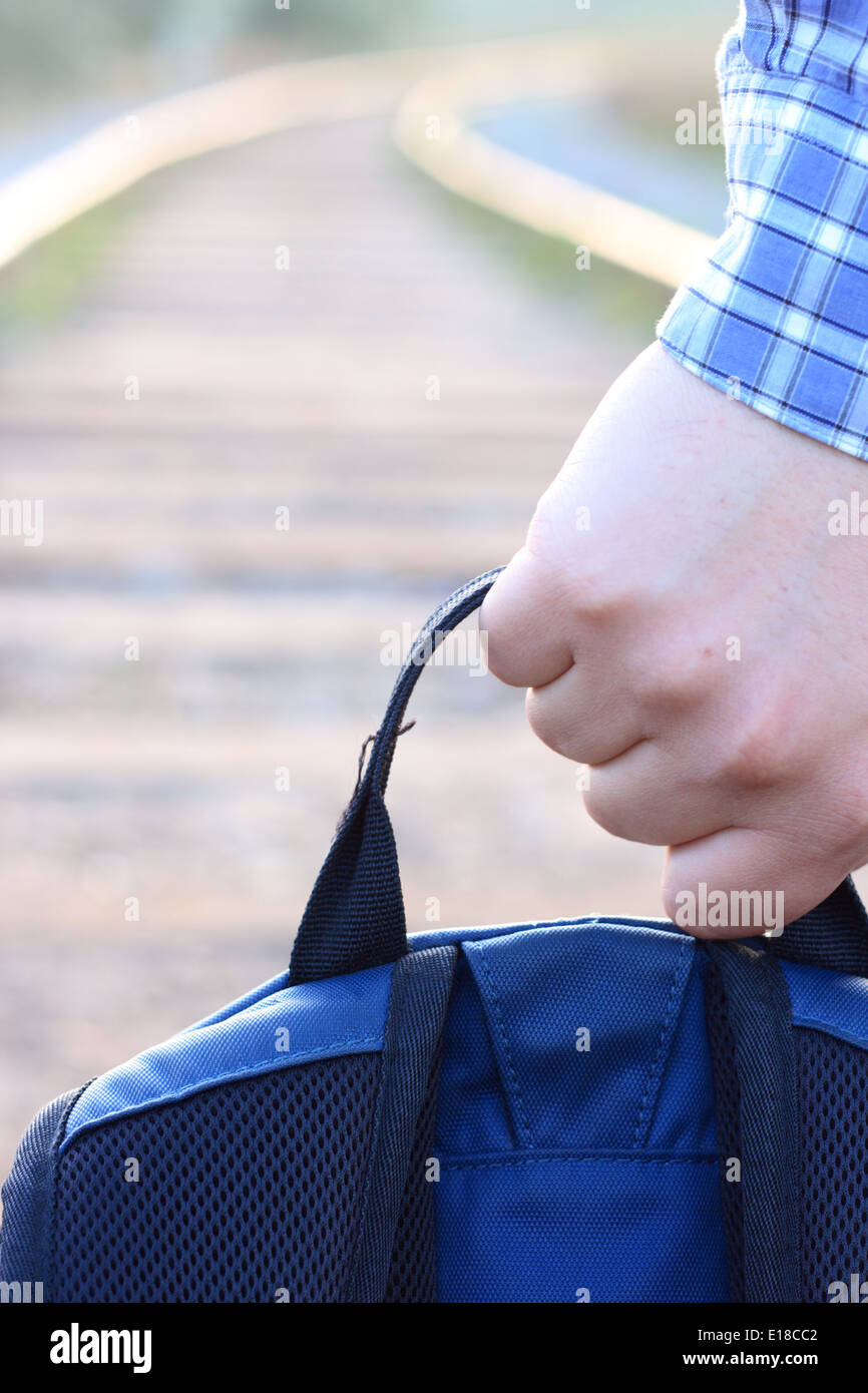 Backpack in a hand Stock Photo - Alamy
