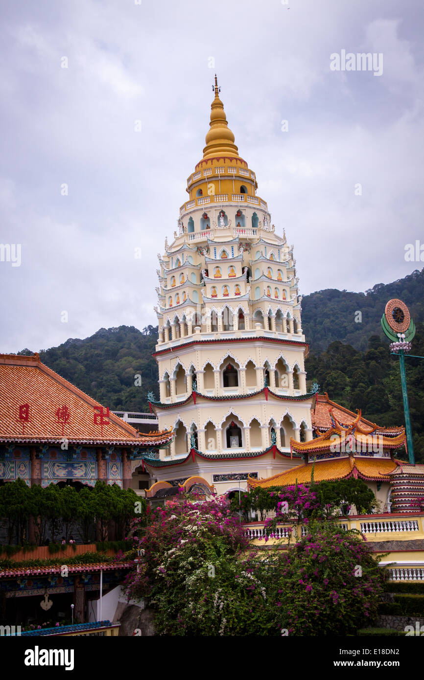 Interior of an ornate Asian temple with statues f deities in recesses ...