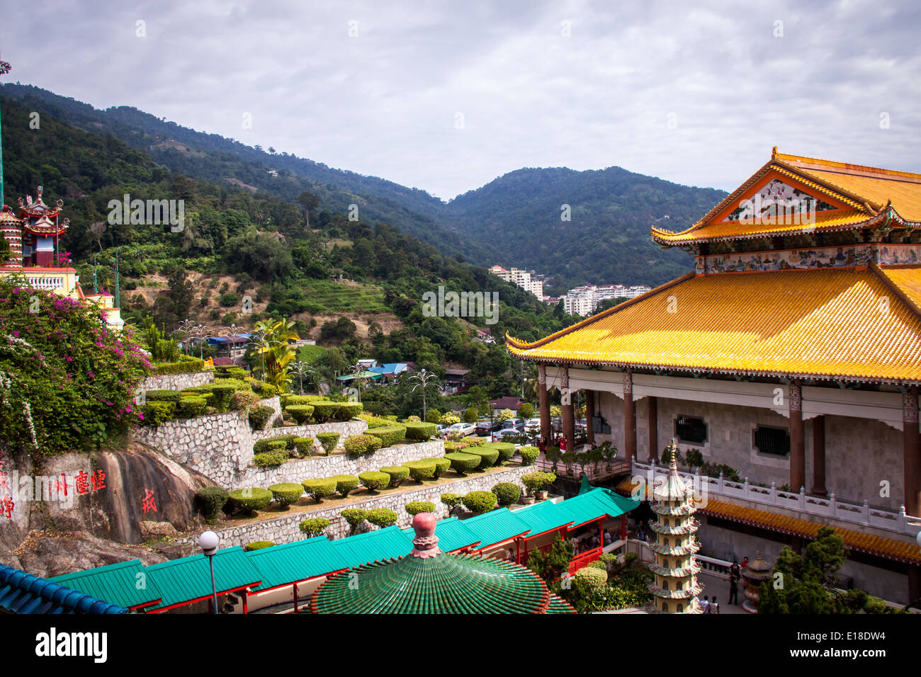 Interior of an ornate Asian temple with statues f deities in recesses ...